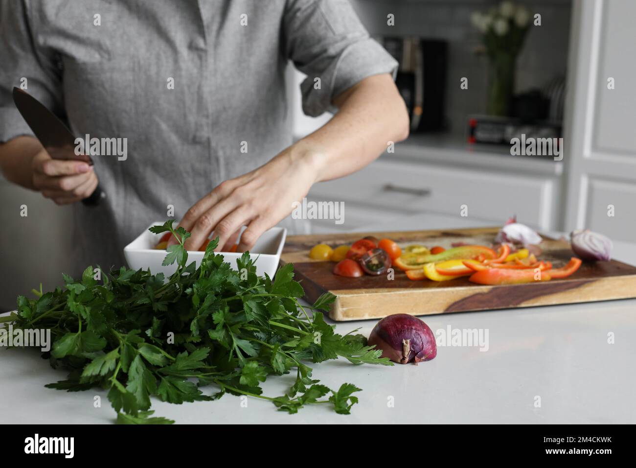 Prepping vegetables with parsley and tomatoes Stock Photo - Alamy
