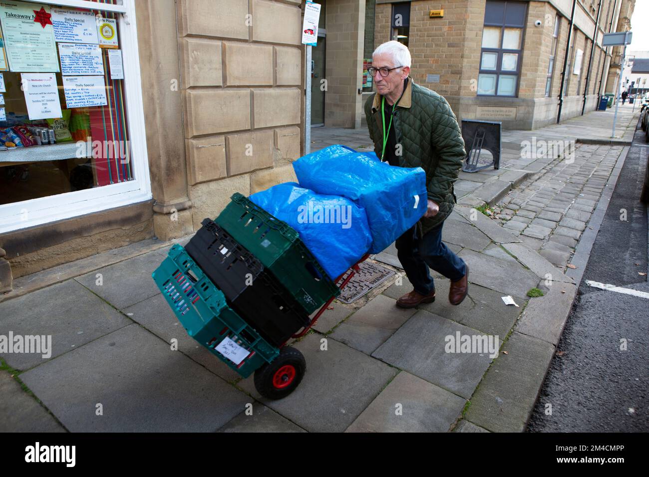 Volunteer worker Michael Blake , 70, pushes a trolley full of food ...
