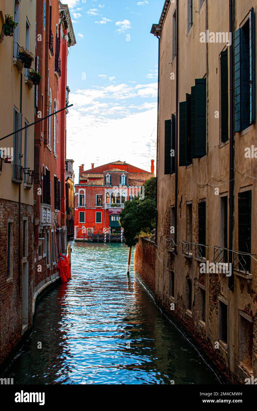 A vertical shot of a water canal flowing between traditional houses in ...