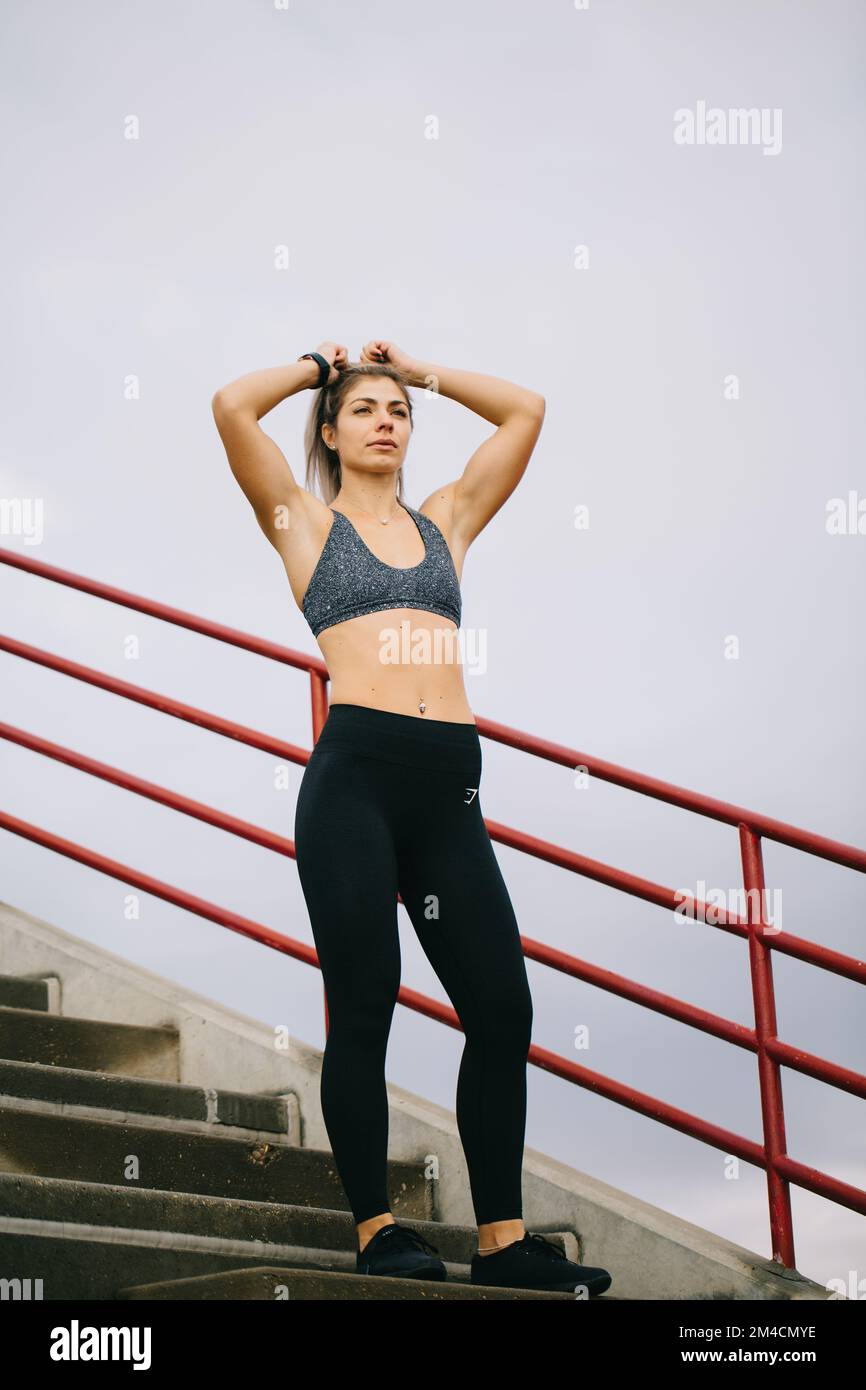 Athletic woman getting ready for a workout outside on a rainy da Stock ...