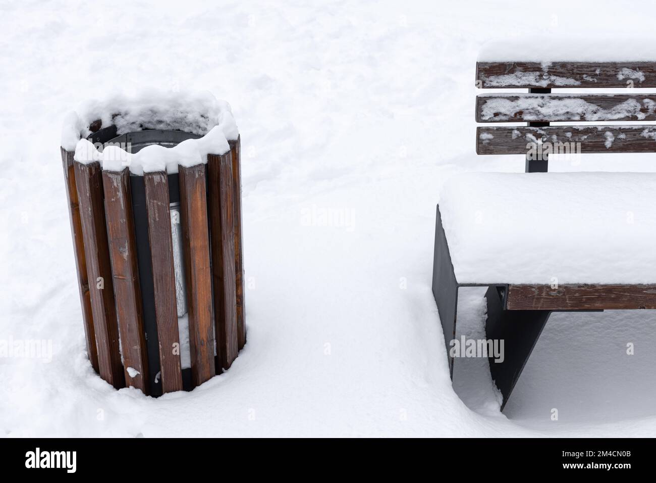 trash can covered with snow in winter park. trash can. garbage ...