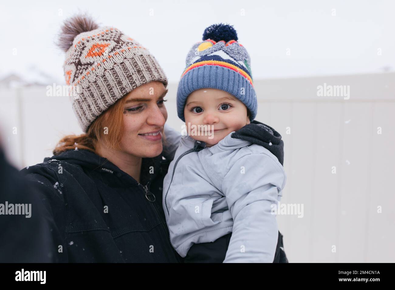 Mom and baby boy taking selfie together outside in the snowfall Stock ...