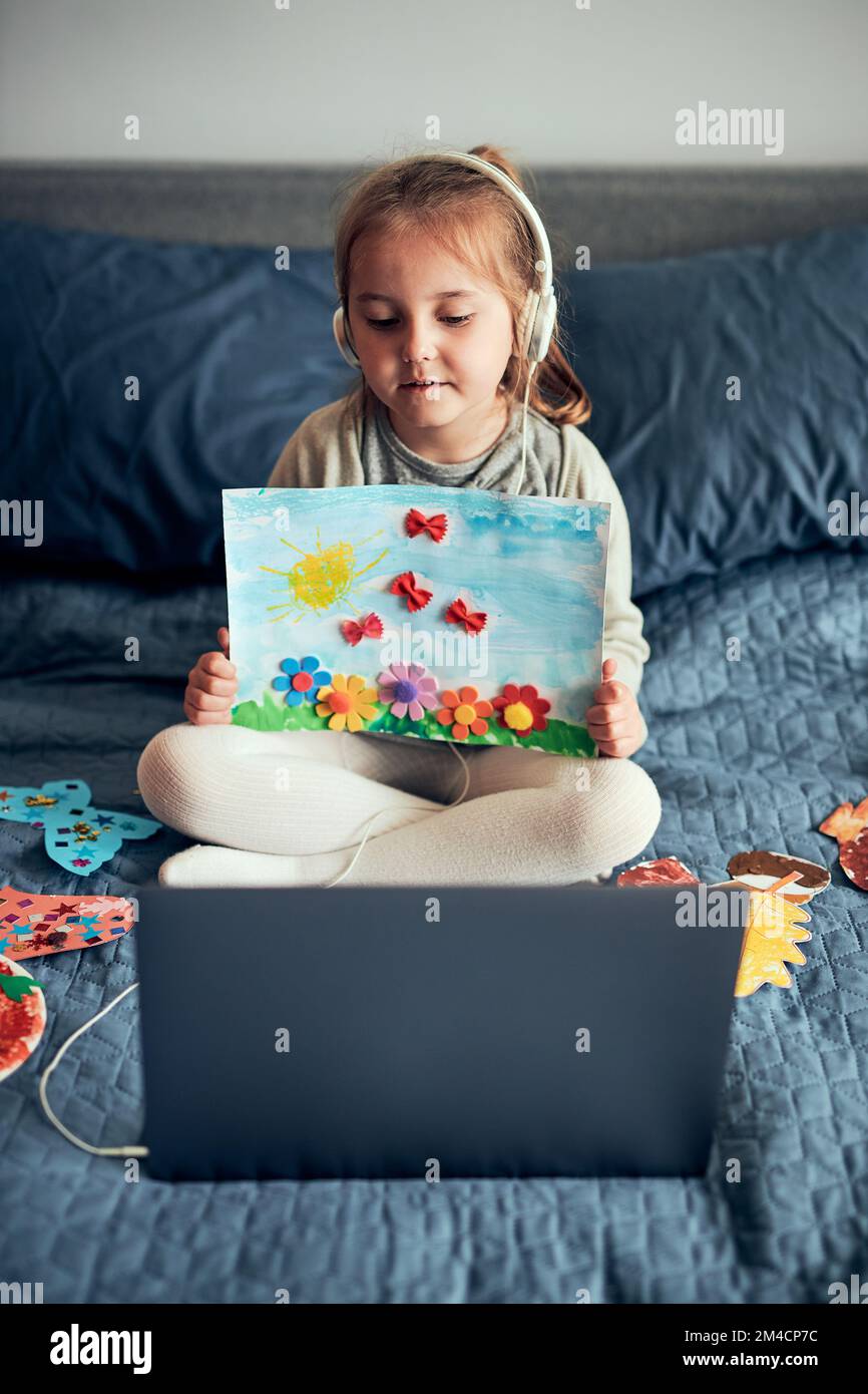 Little girl preschooler learning online showing her works drawings done ...
