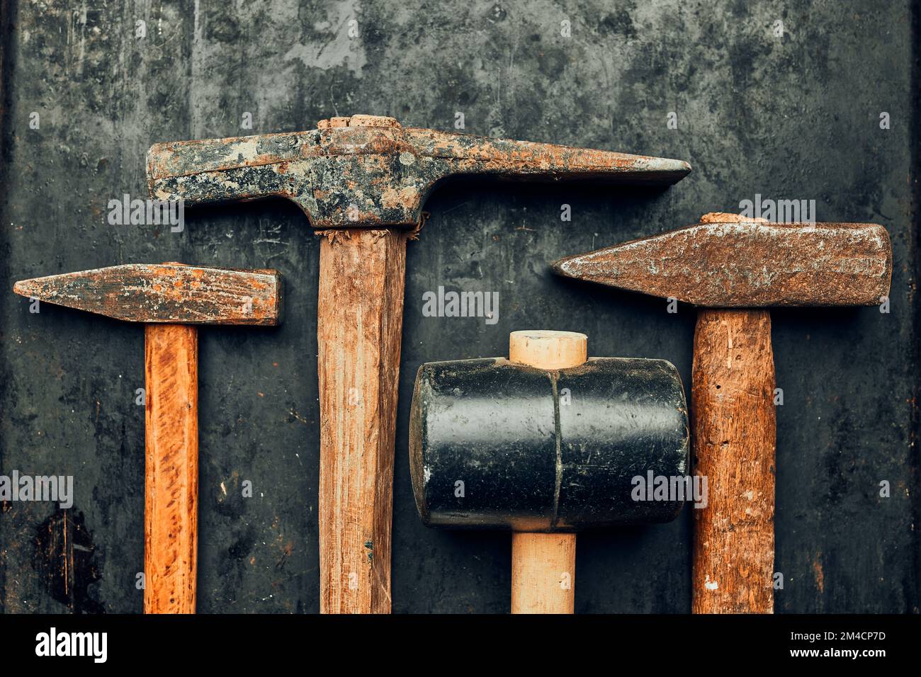 Old hammers on steel surface. Rusty tools for maintenance. Hardware ...