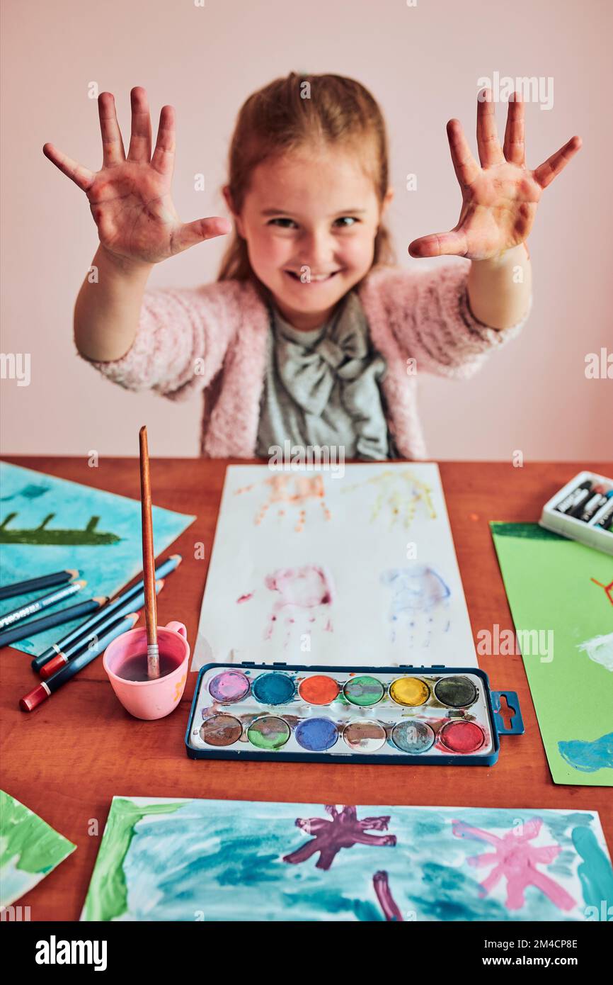 Little girl preschooler showing painted colourful hands. Child having ...