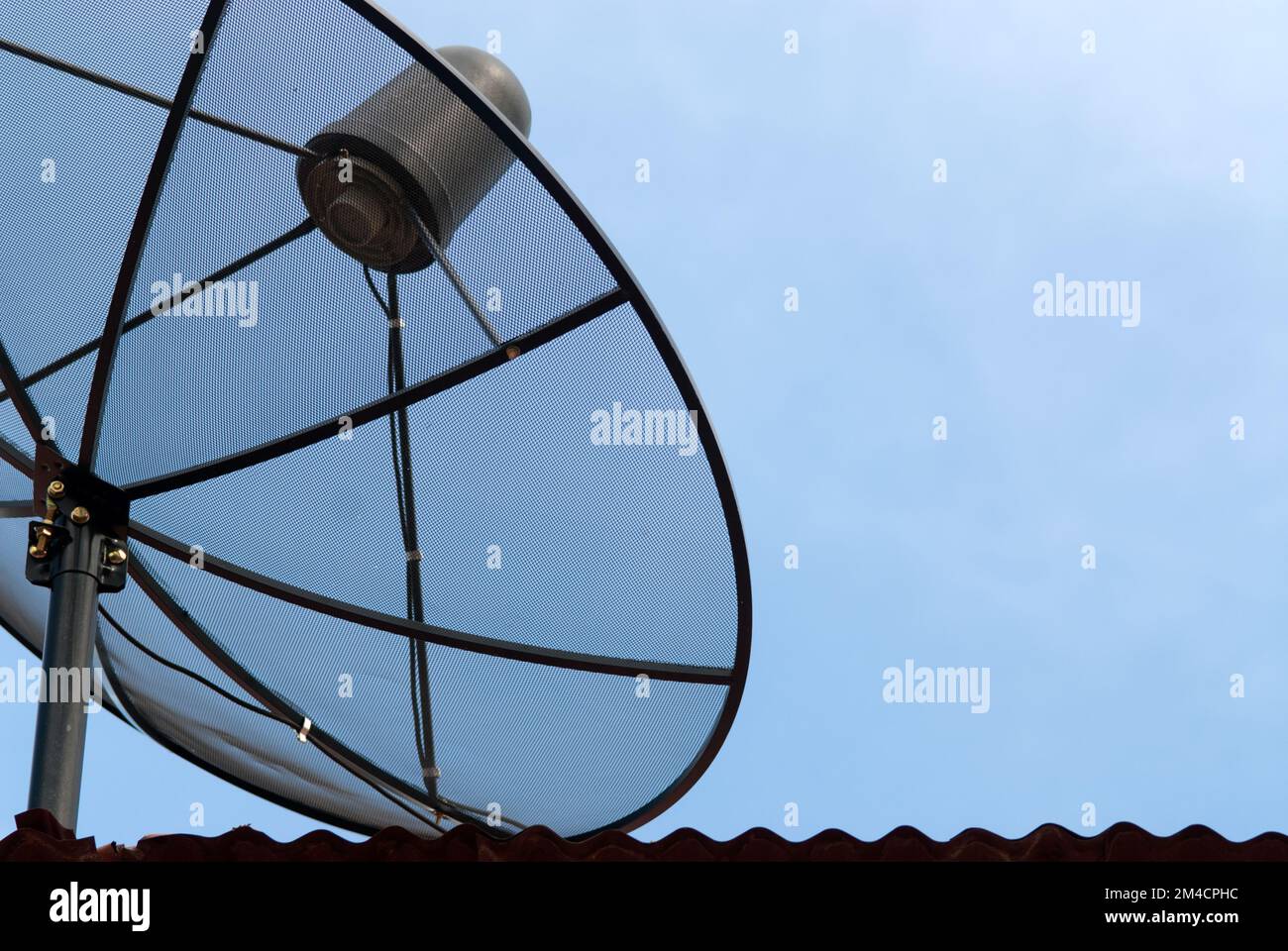 Big black satellite dish on roof Stock Photo - Alamy