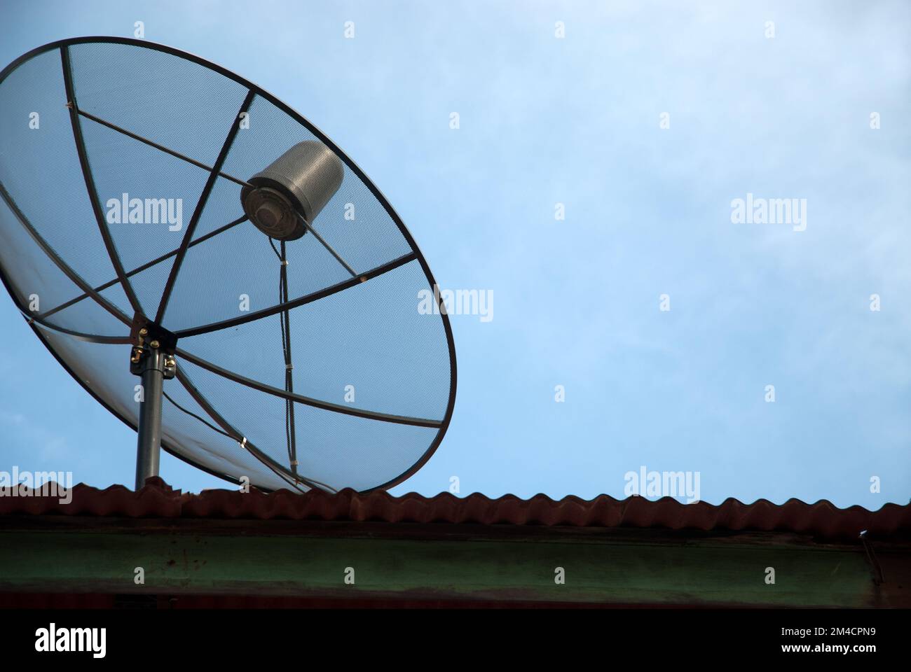 Big black satellite dish on roof Stock Photo - Alamy