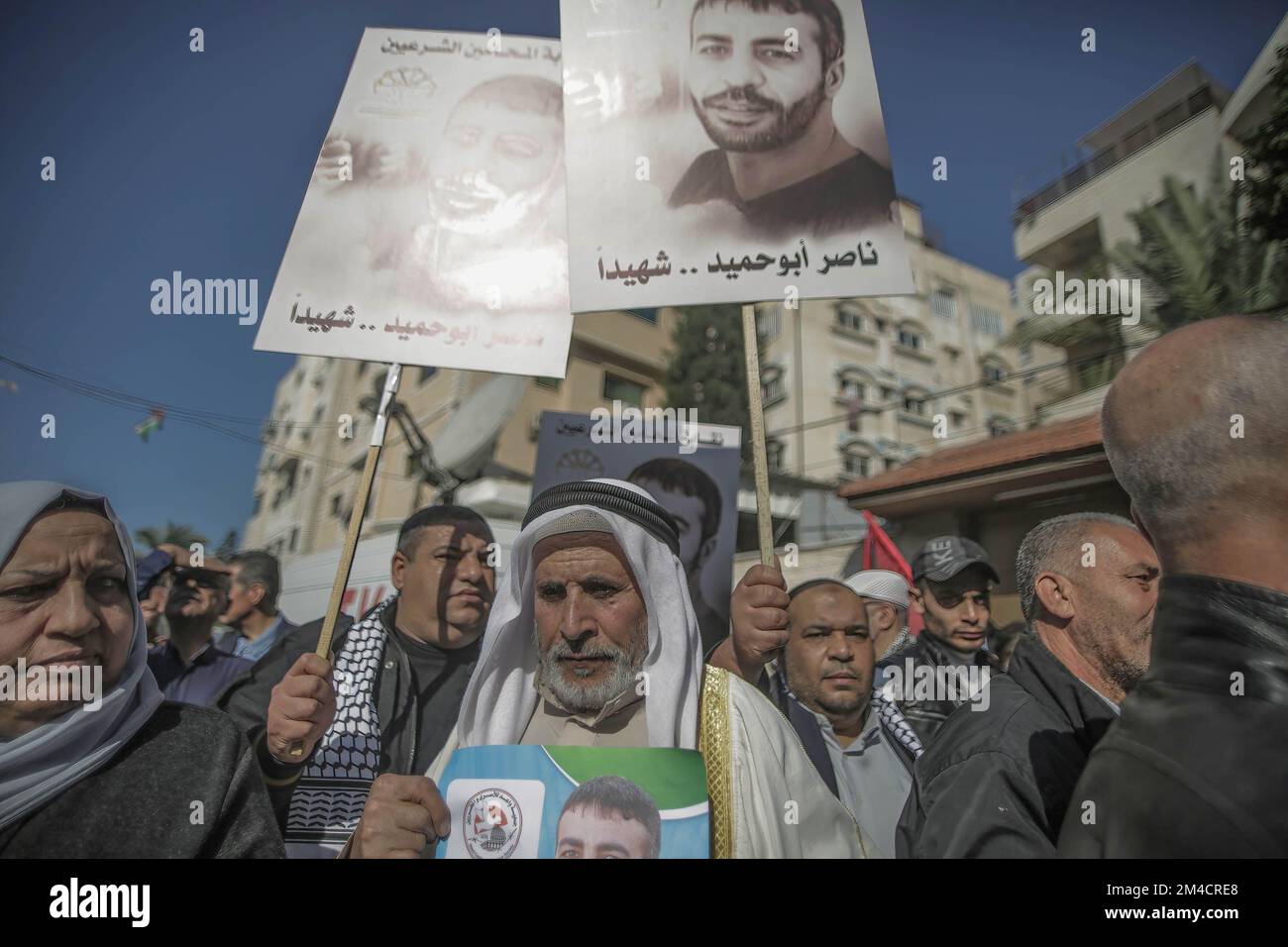 Palestinians hold posters of Palestinian prisoner Nasser Abu Hamid ...