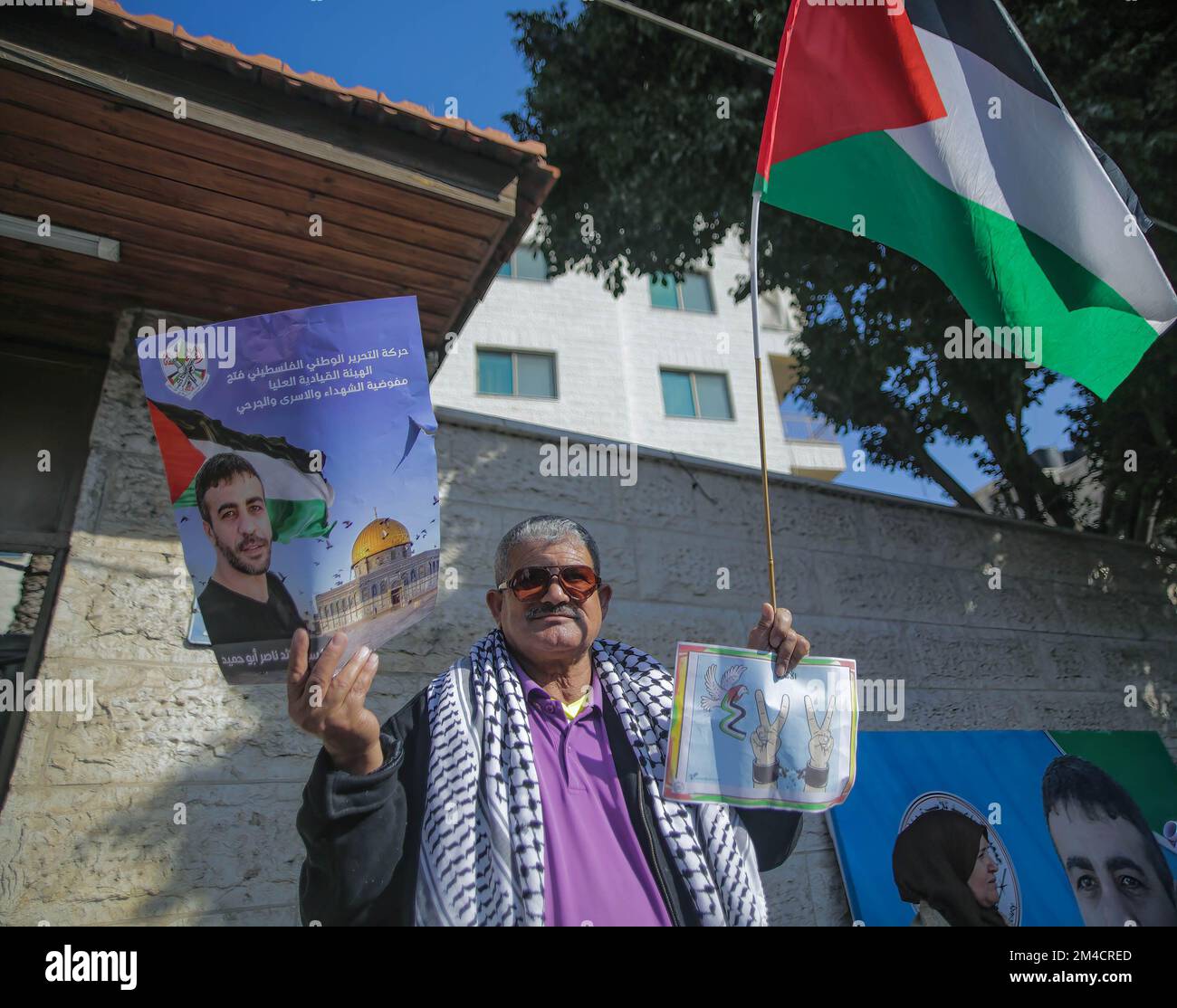 Palestinians hold posters of Palestinian prisoner Nasser Abu Hamid ...