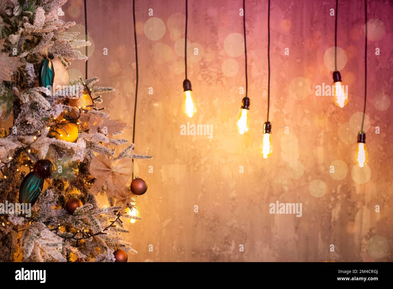 Christmas tree decorated with crafts and toys against a structural wall ...