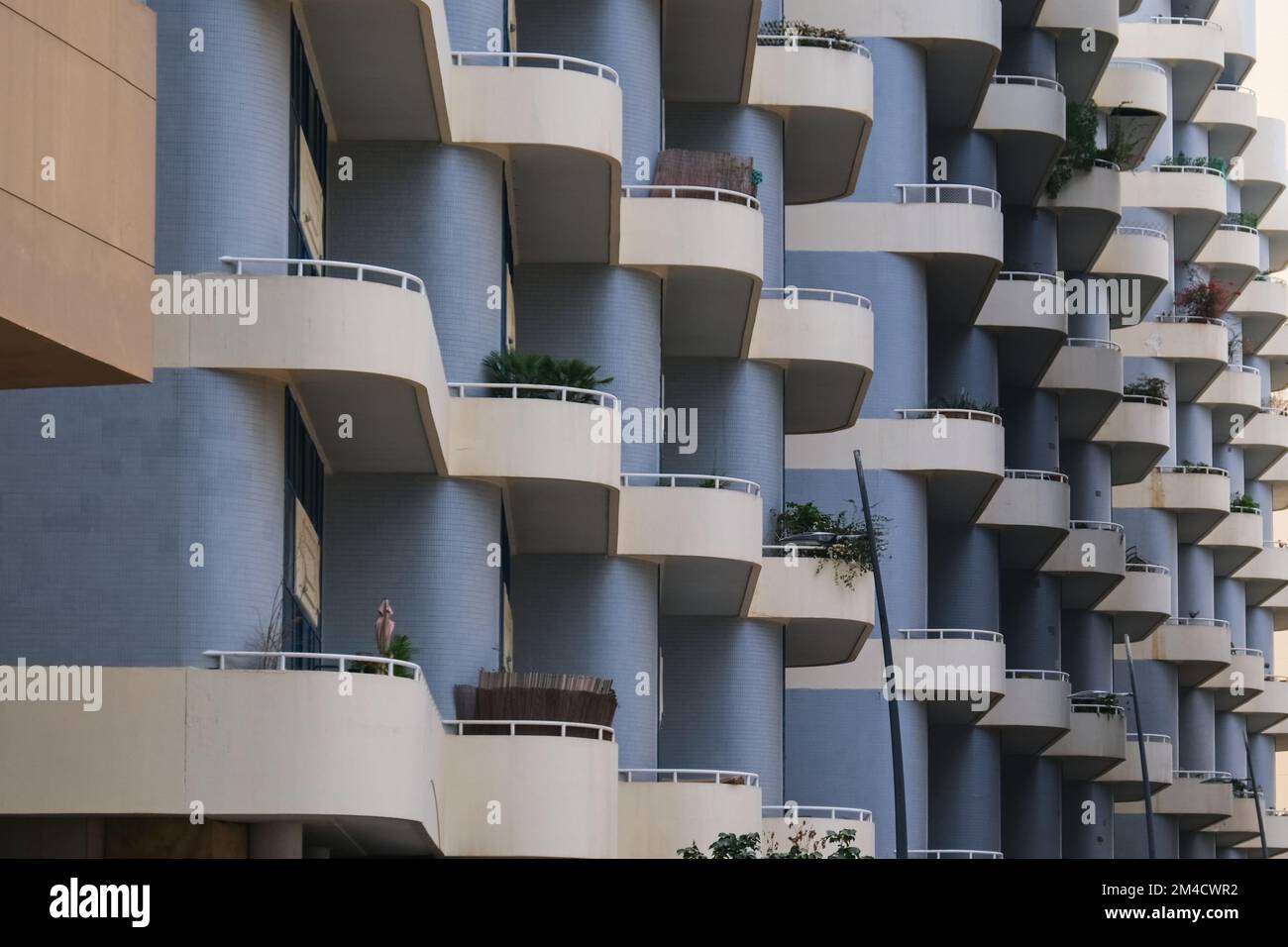 Facade of modern residential apartment building with curved balconies ...