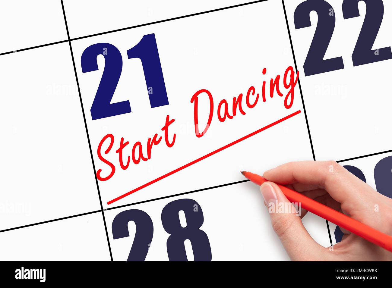 21st day of the month. Hand writing text START DANCING and drawing a ...