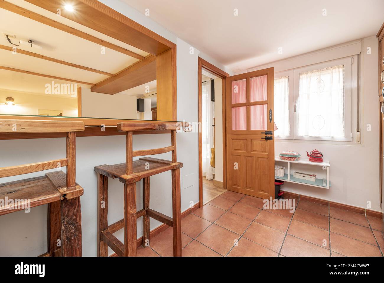 Country-style kitchen with serving hatch with wooden bar and high ...