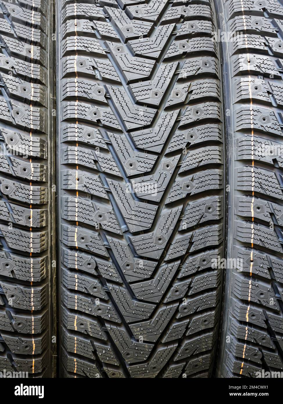 New modern studdable winter tire tread closeup withouts studs, vertical ...