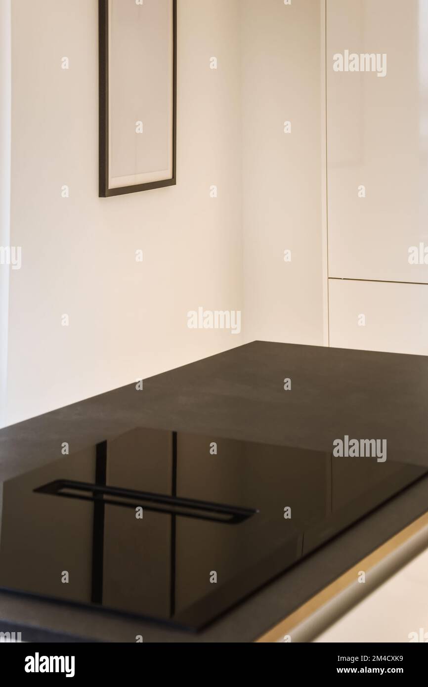 a black counter top in a white room with two framed pictures on the ...