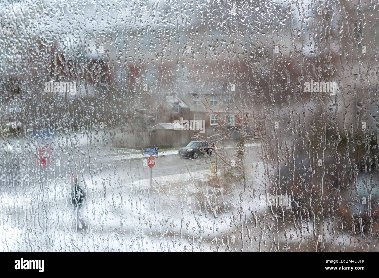 A winter storm caused rain and snow to draw a pattern on the window ...
