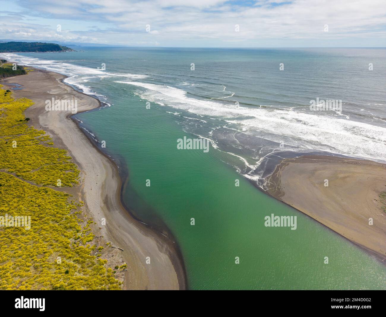 Aerial shot of the point where the river Tolten flows into the pacific ...