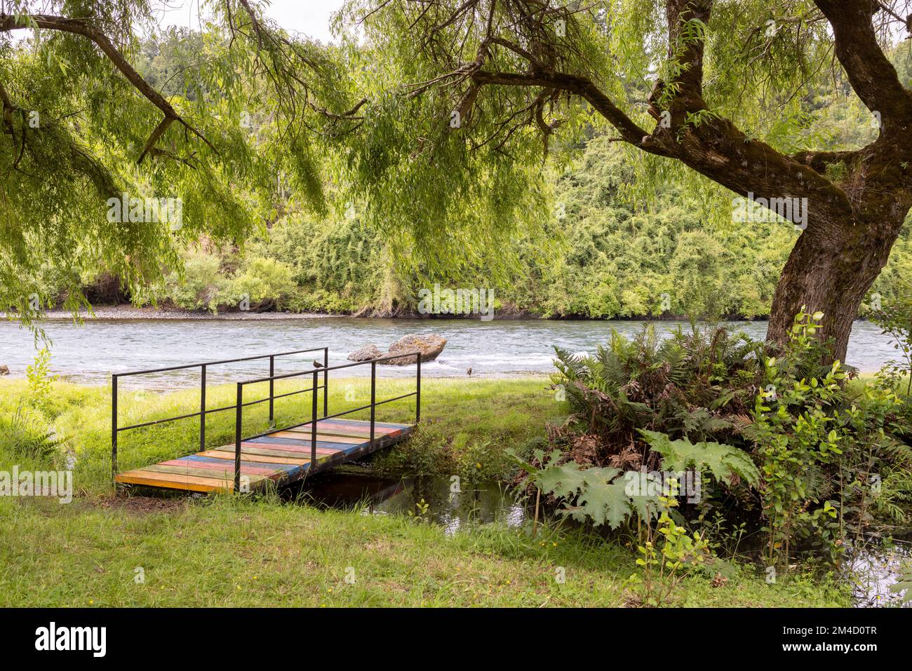 Colorful wooden bridge leading to the River Tolten in Araucania, Chile ...