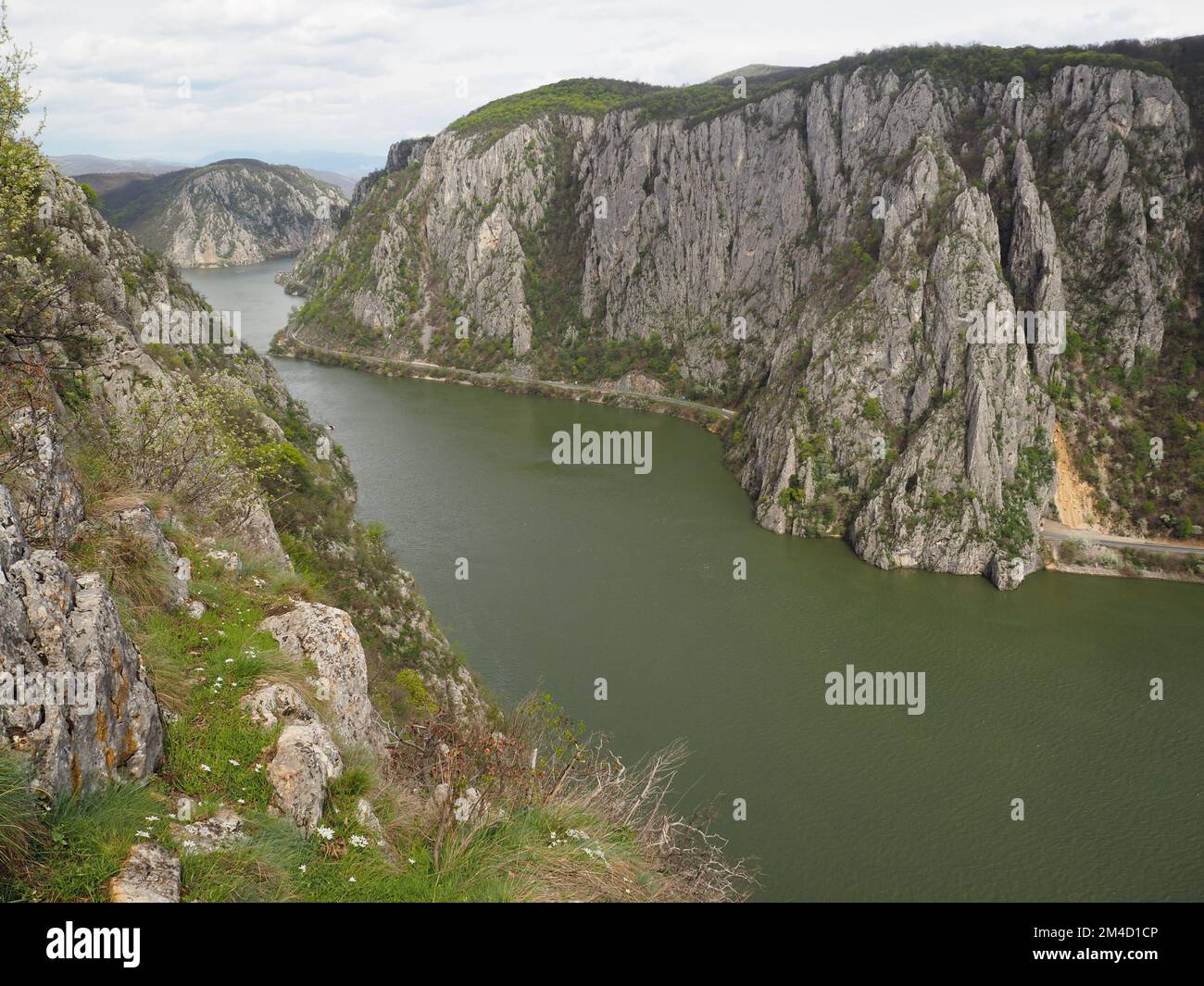 The green river surrounded by cliffs creates a beautiful environmental ...