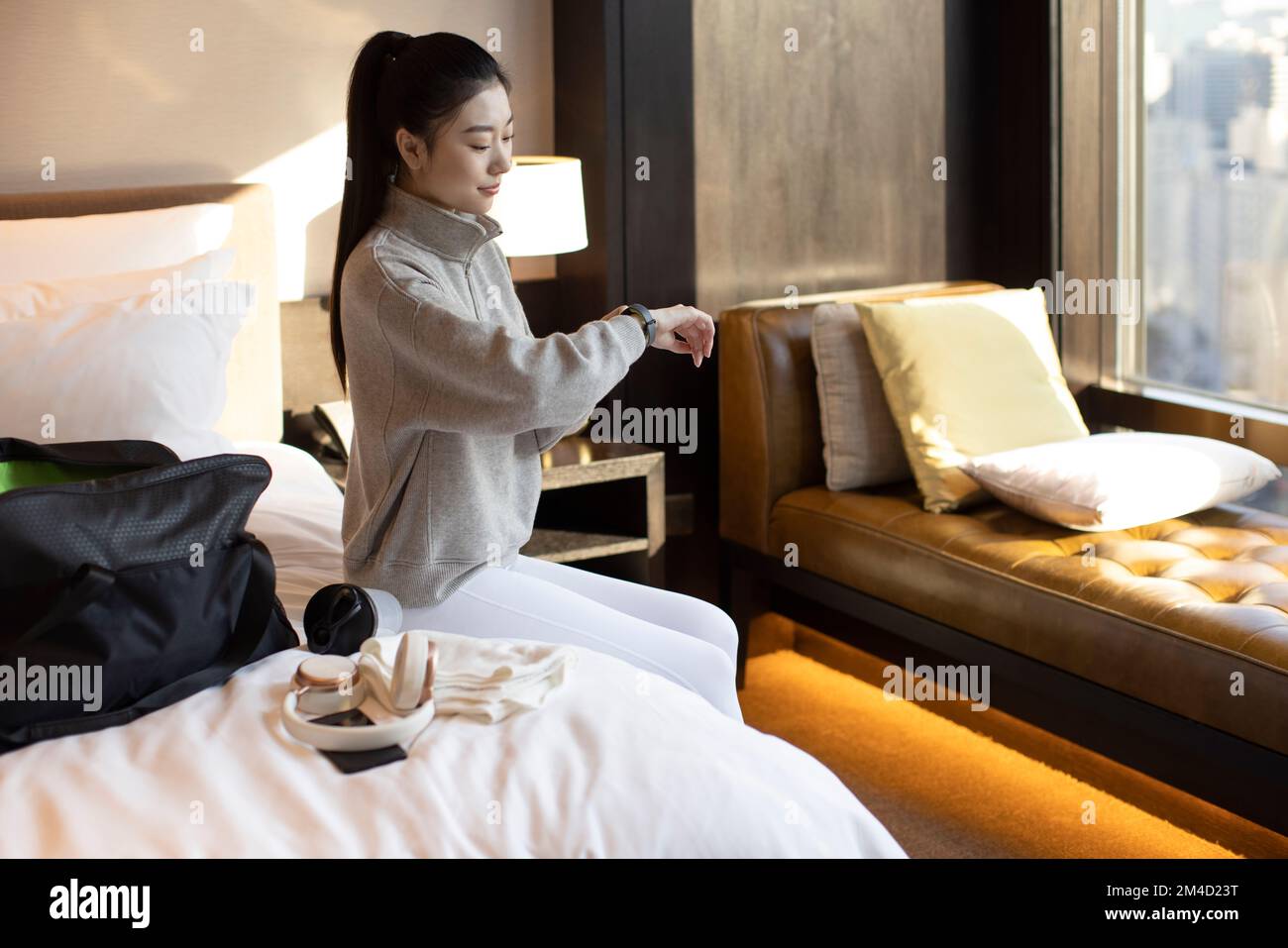 Young Chinese woman getting ready to go out and workout Stock Photo - Alamy
