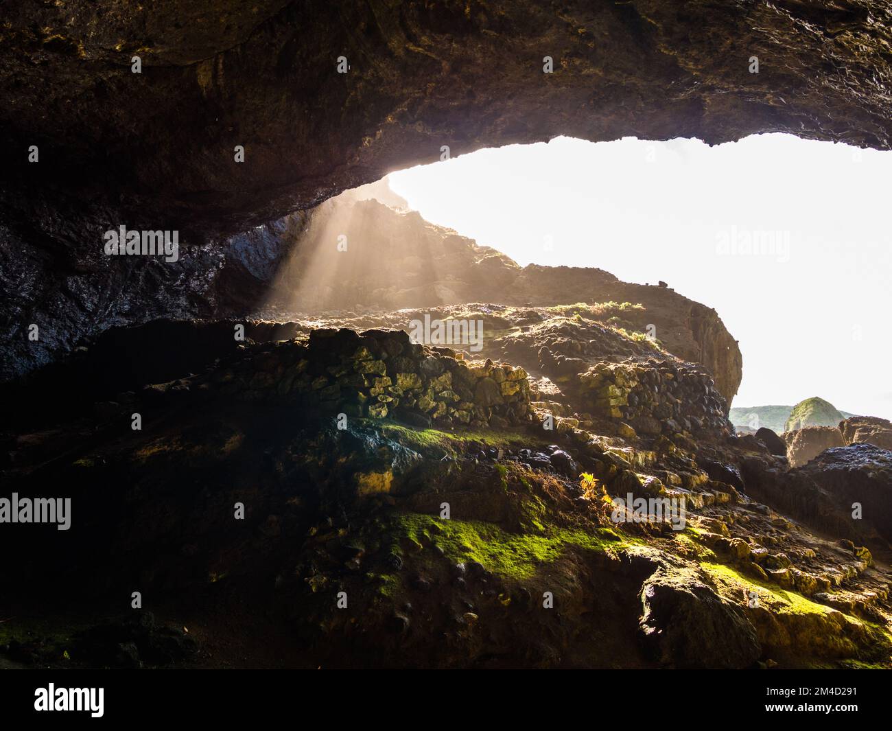 View from sea cave with ancient steps and sun rays Stock Photo - Alamy