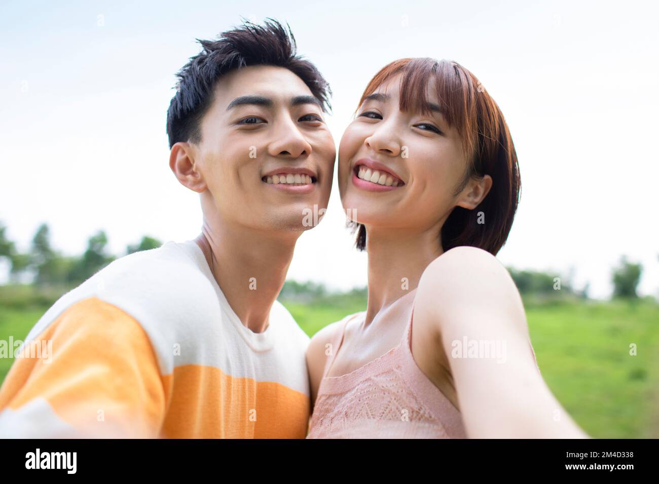 Happy young Chinese couple dating outdoors Stock Photo - Alamy