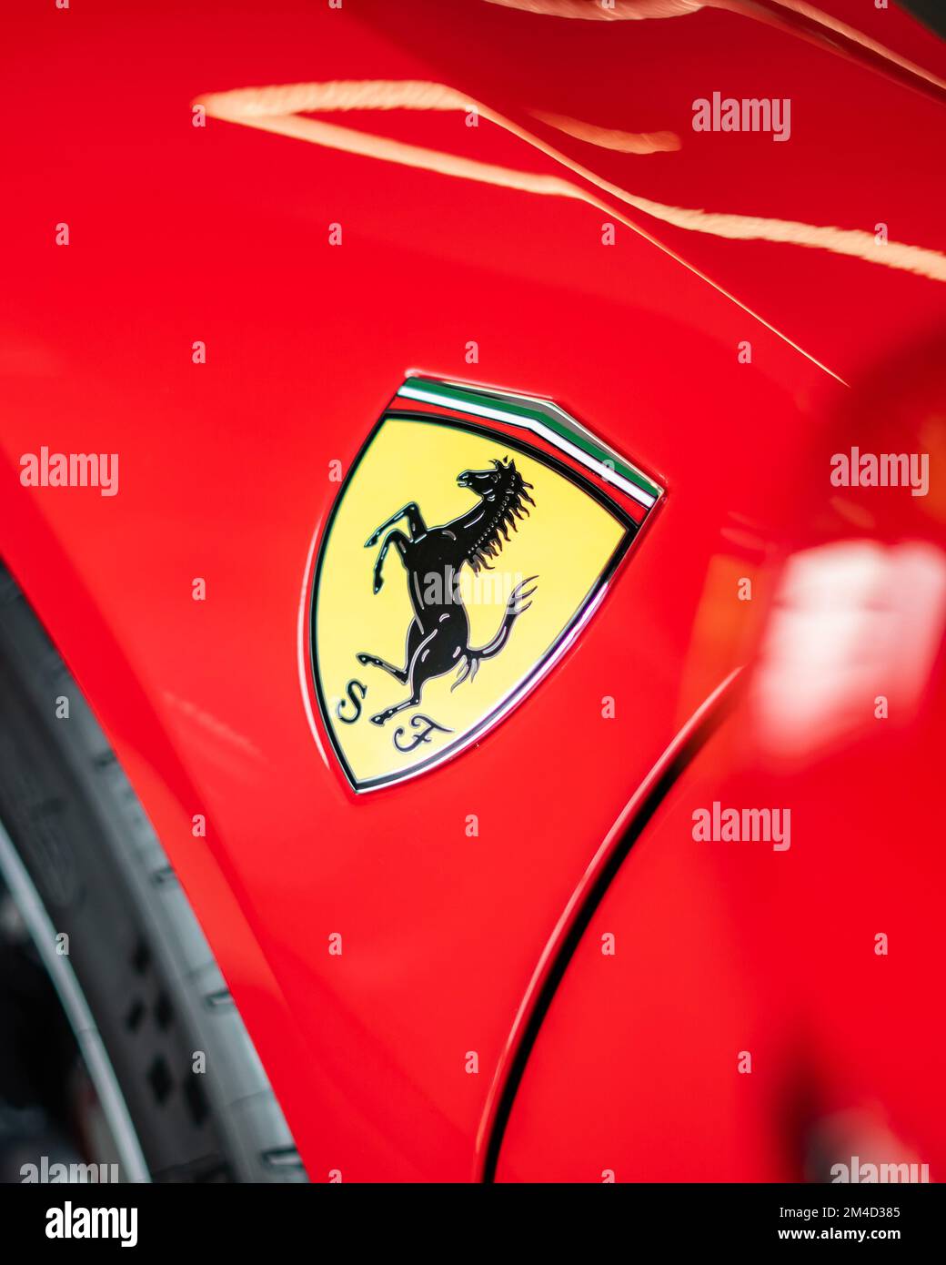 A high-angle vertical shot of Ferrari logo badge on the red car Stock ...