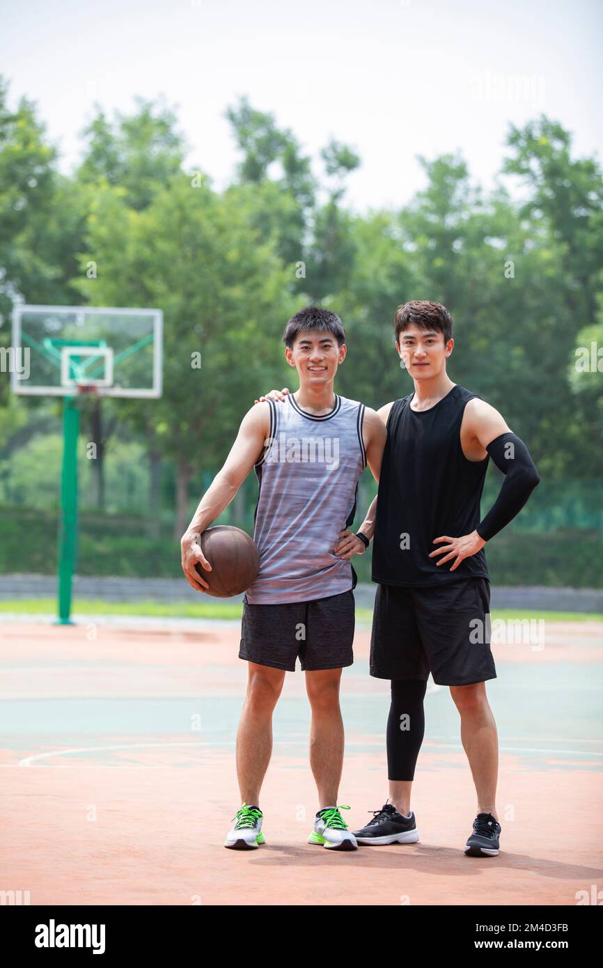 Happy young Chinese men playing basketball outdoors Stock Photo - Alamy