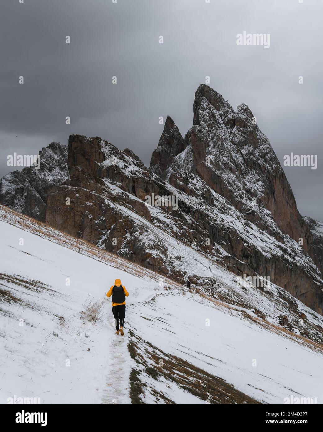 A lone hiker trekking near the Seceda mountain peak in the Dolomite ...