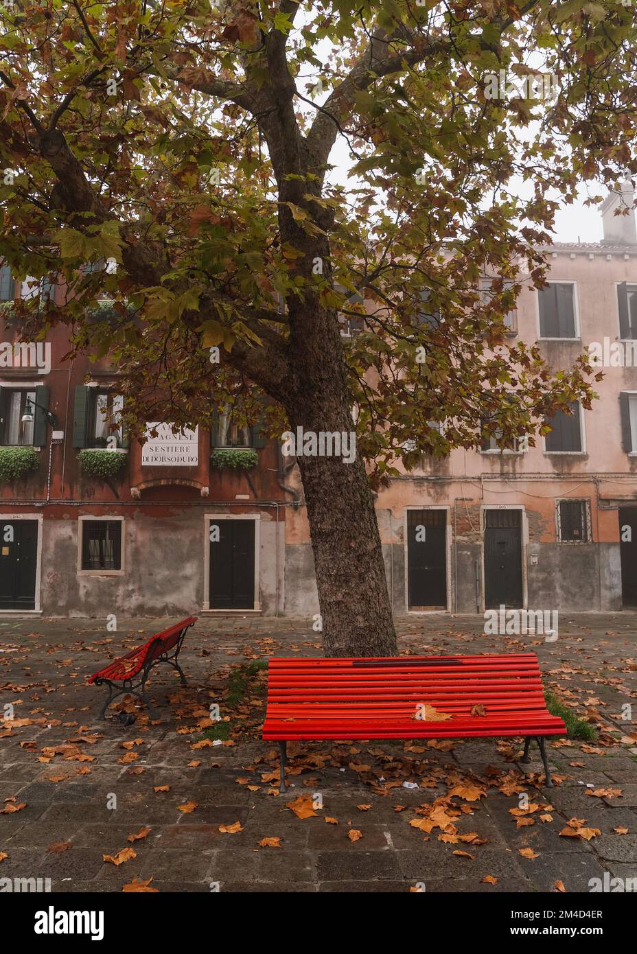 Red park benches in city square - Venice, Italy Stock Photo - Alamy