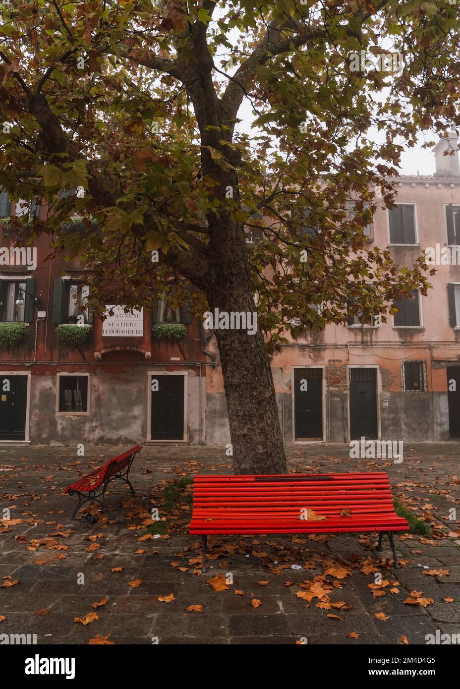 Red park benches in city square - Venice, Italy Stock Photo - Alamy