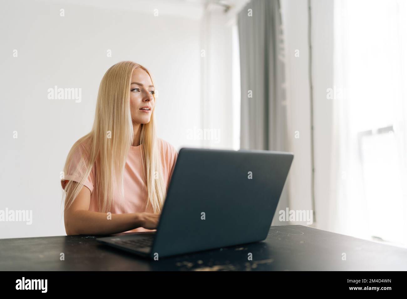 Studio portrait of pensive injured female freelancer with broken arm ...