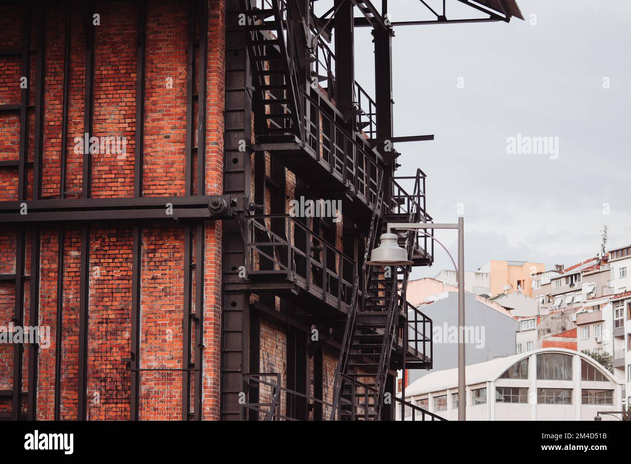 A red brick stone building with iron parts and stairs in the city ...
