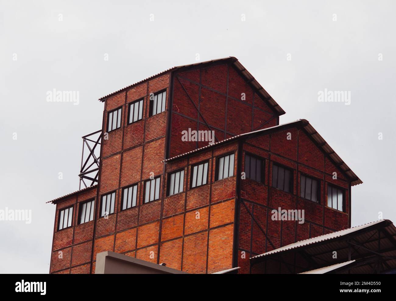 A red brick stone building with iron parts and windows in the city ...