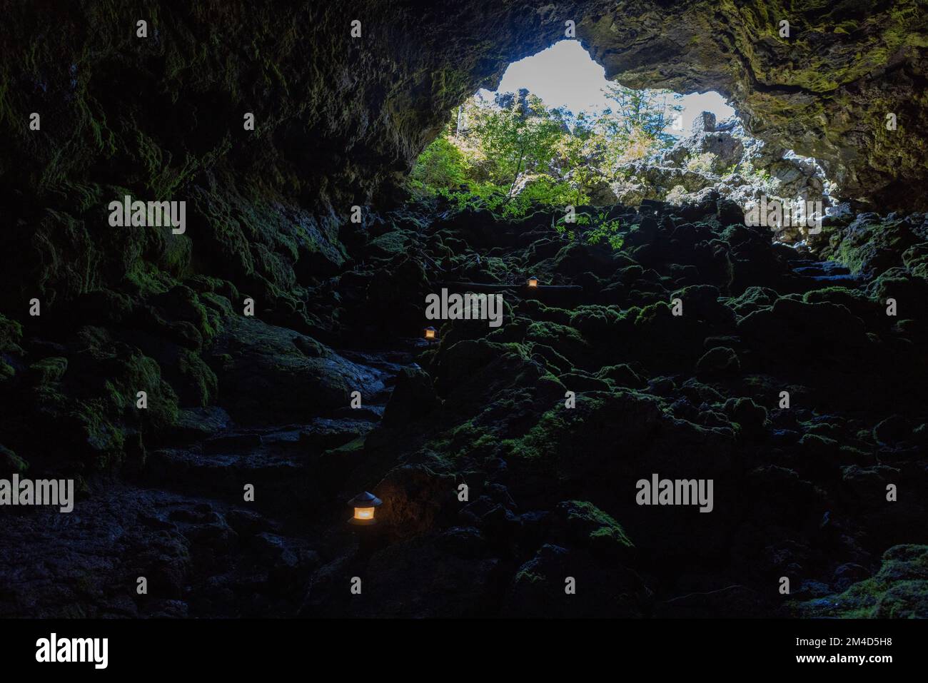 Entrance of a volcanic cave in the Volcanic Caves Park at the foot of ...