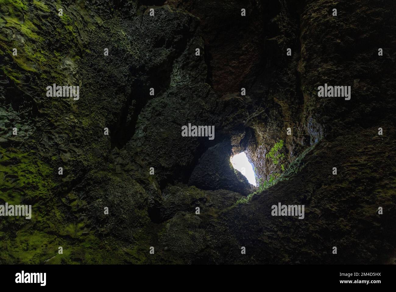 Exploring a volcanic cave in the Volcanic Caves Park at the foot of ...