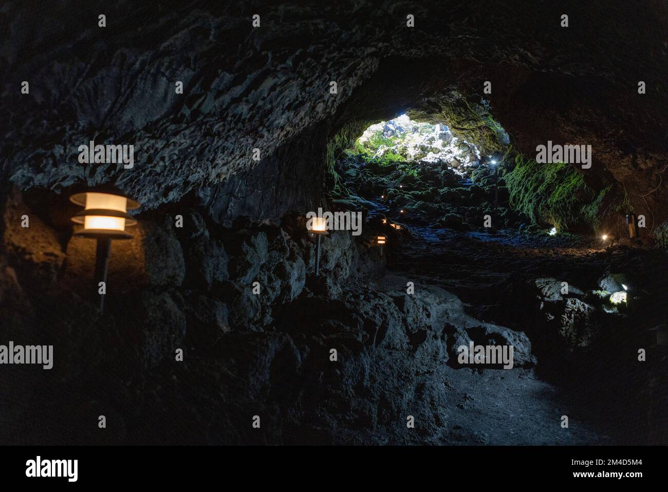 Exploring a volcanic cave in the Volcanic Caves Park at the foot of ...