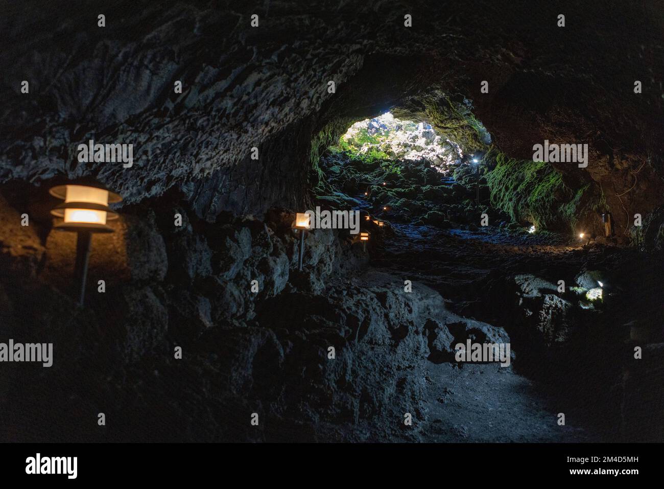 Exploring a volcanic cave in the Volcanic Caves Park at the foot of ...