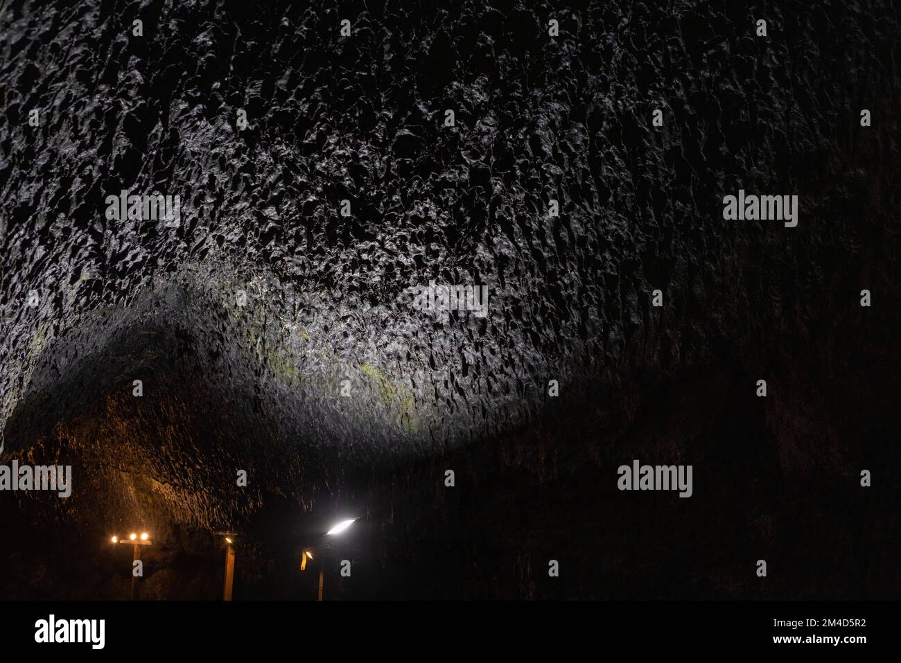 Exploring a volcanic cave in the Volcanic Caves Park at the foot of ...