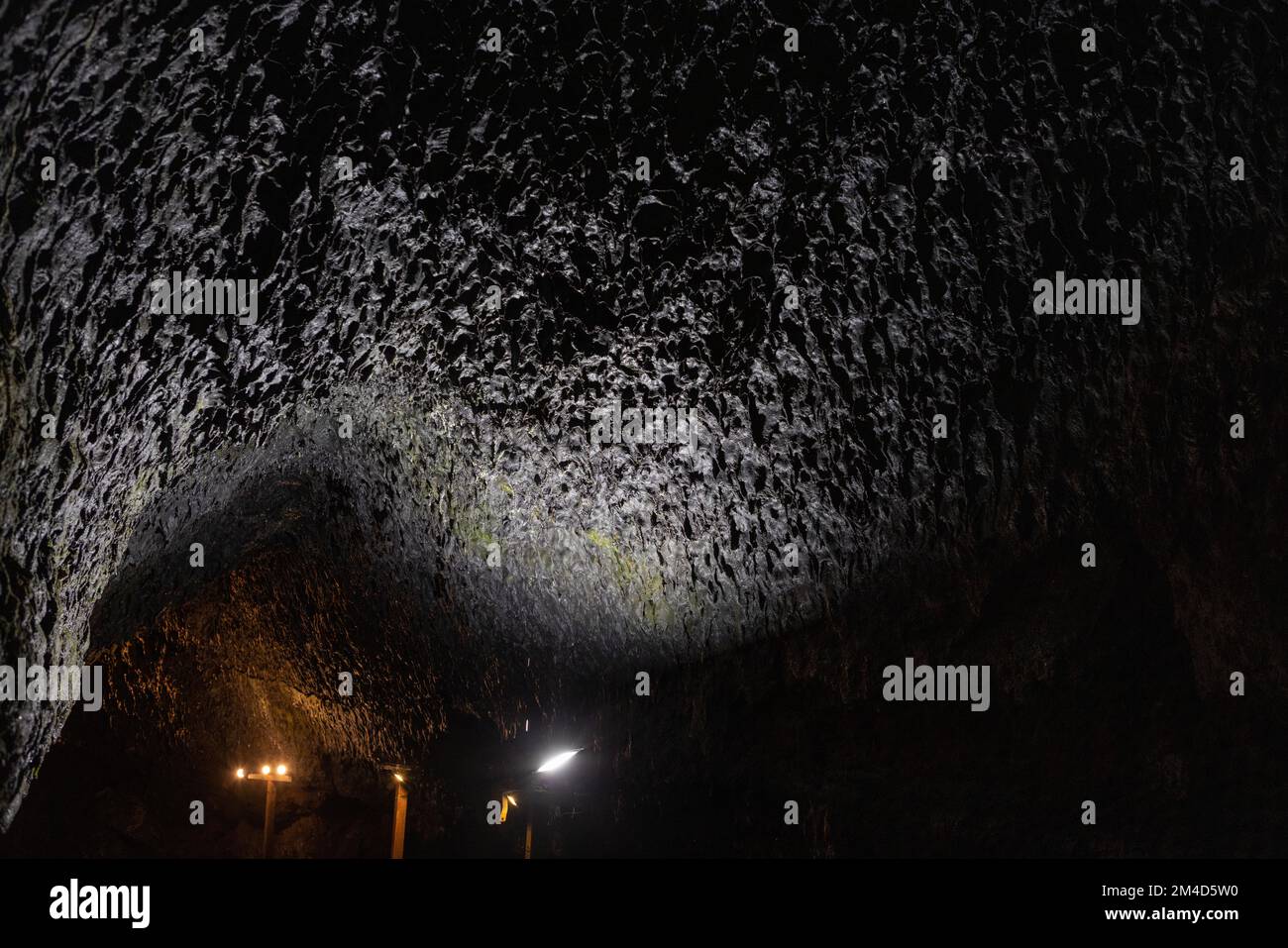 Exploring a volcanic cave in the Volcanic Caves Park at the foot of ...
