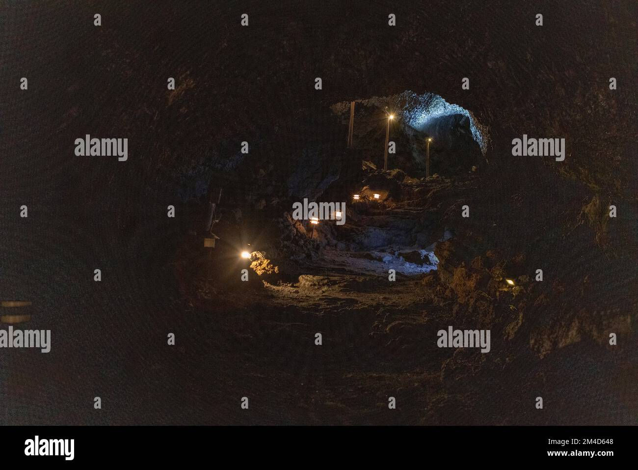 Exploring a volcanic cave in the Volcanic Caves Park at the foot of ...