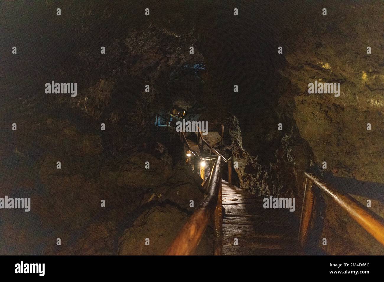 Exploring a volcanic cave in the Volcanic Caves Park at the foot of ...