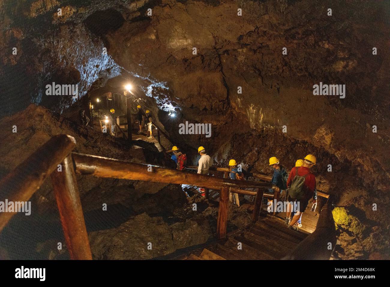 Group exploring a volcanic cave in the Volcanic Caves Park at the foot ...