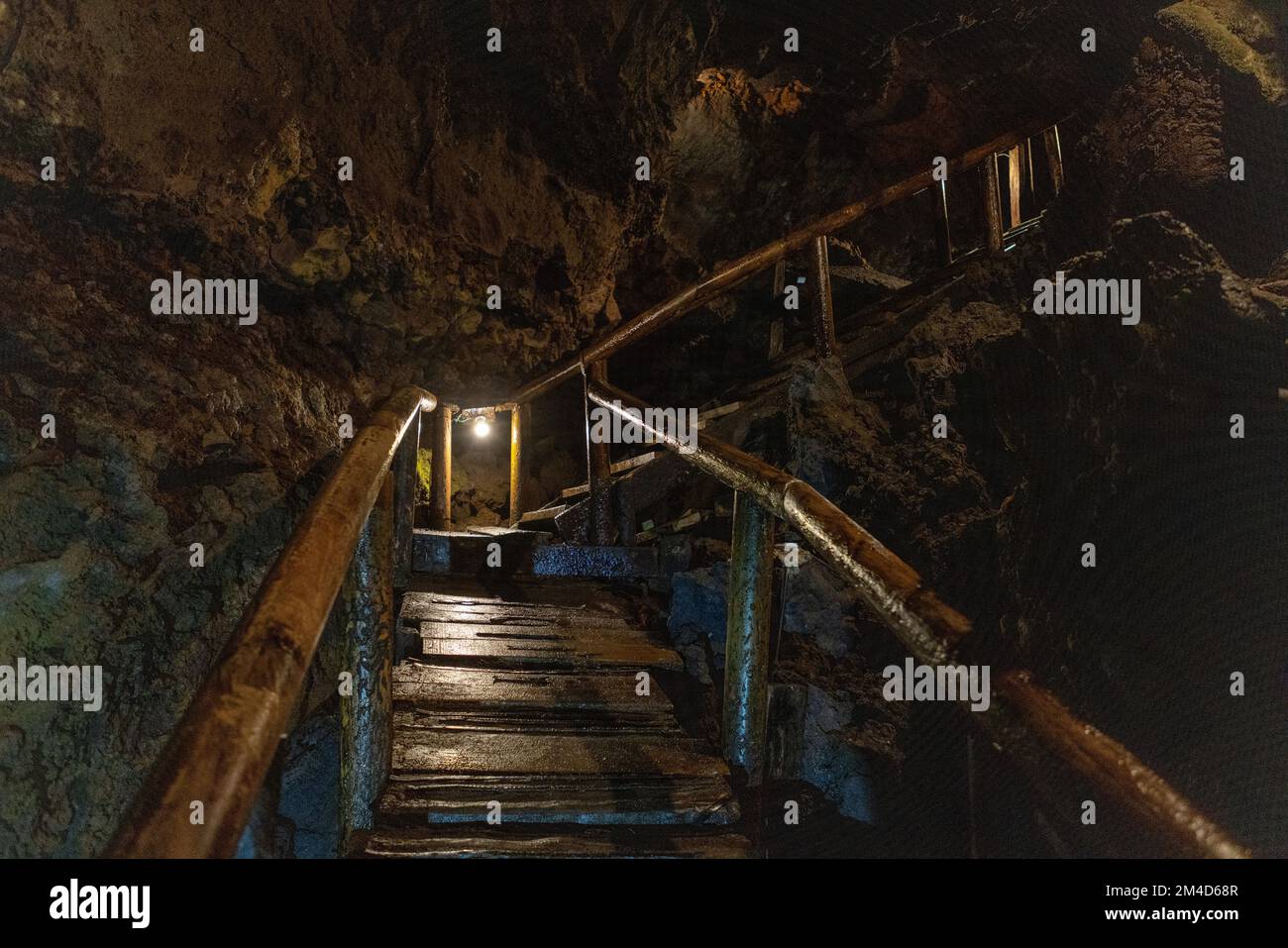 Exploring a volcanic cave in the Volcanic Caves Park at the foot of ...