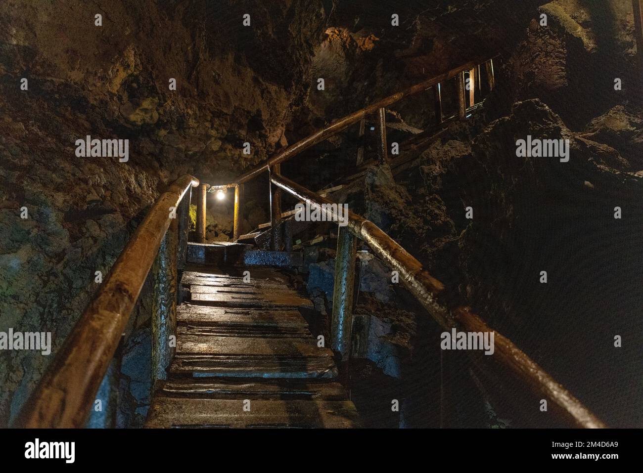 Exploring a volcanic cave in the Volcanic Caves Park at the foot of ...