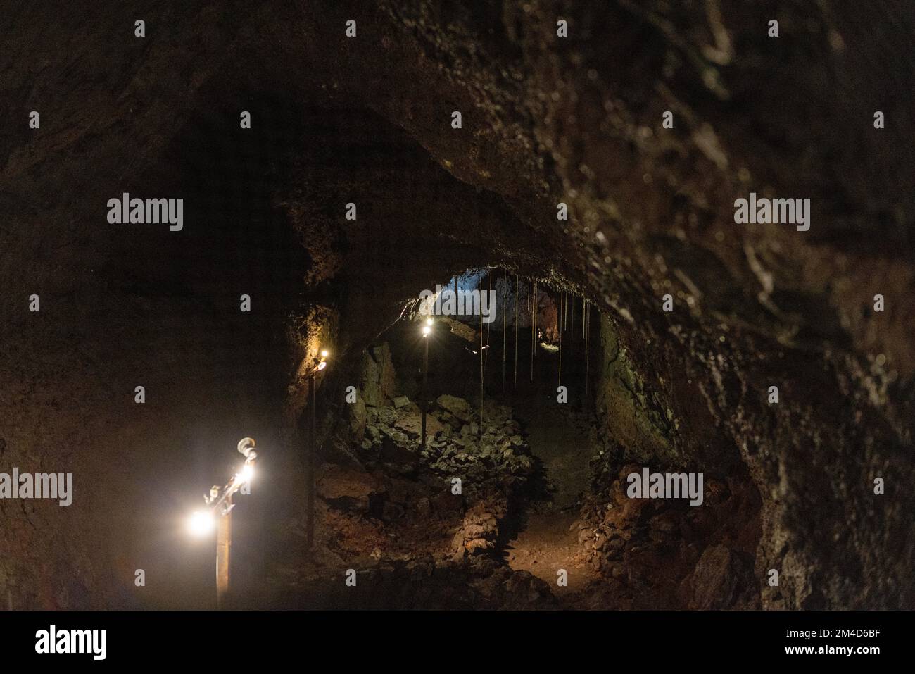 Exploring a volcanic cave in the Volcanic Caves Park at the foot of ...