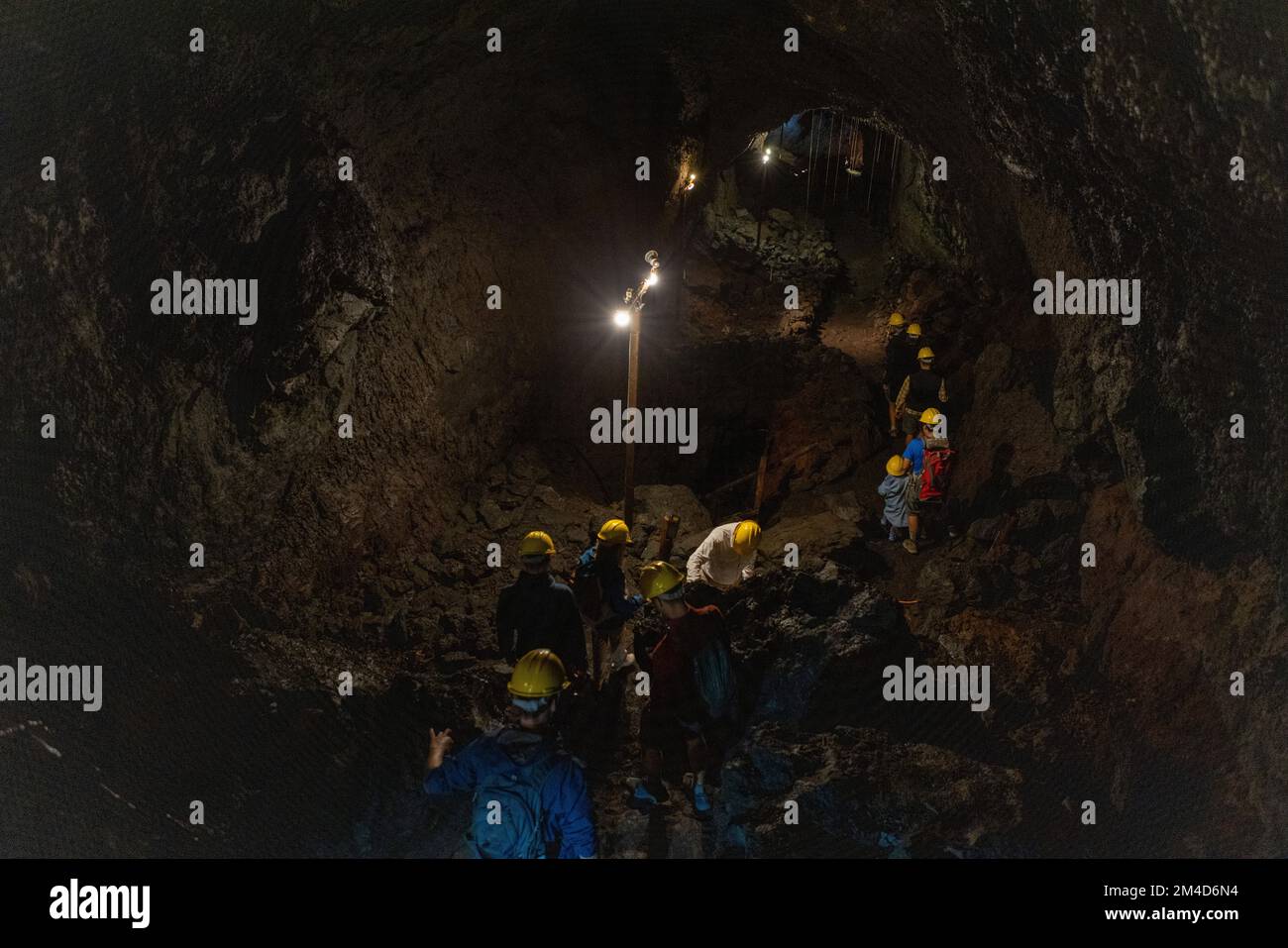 Group exploring a volcanic cave in the Volcanic Caves Park at the foot ...