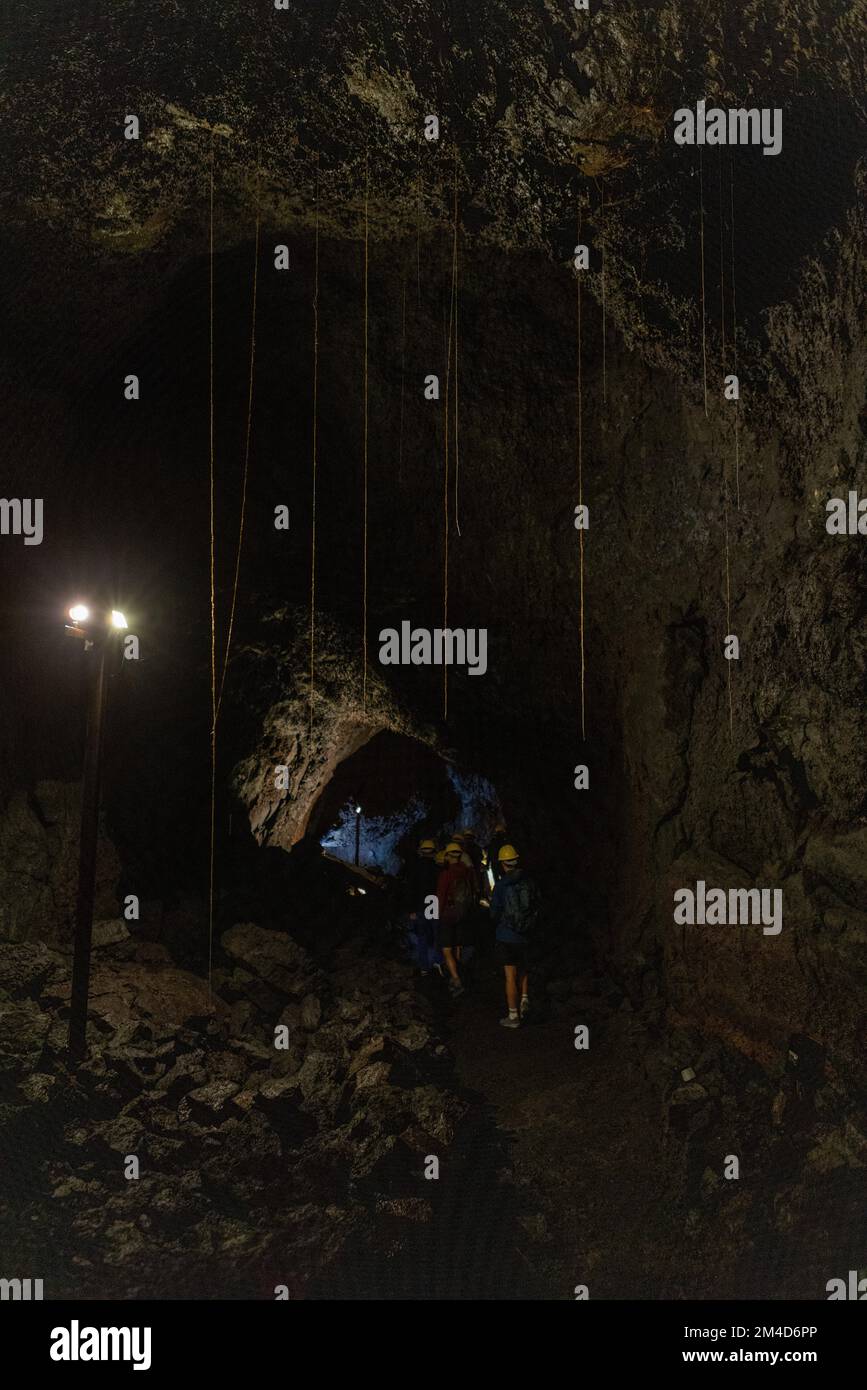 Exploring a volcanic cave in the Volcanic Caves Park at the foot of ...