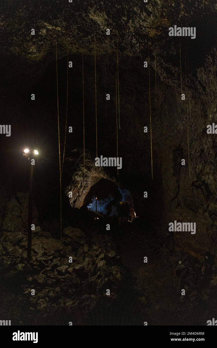 Exploring a volcanic cave in the Volcanic Caves Park at the foot of ...