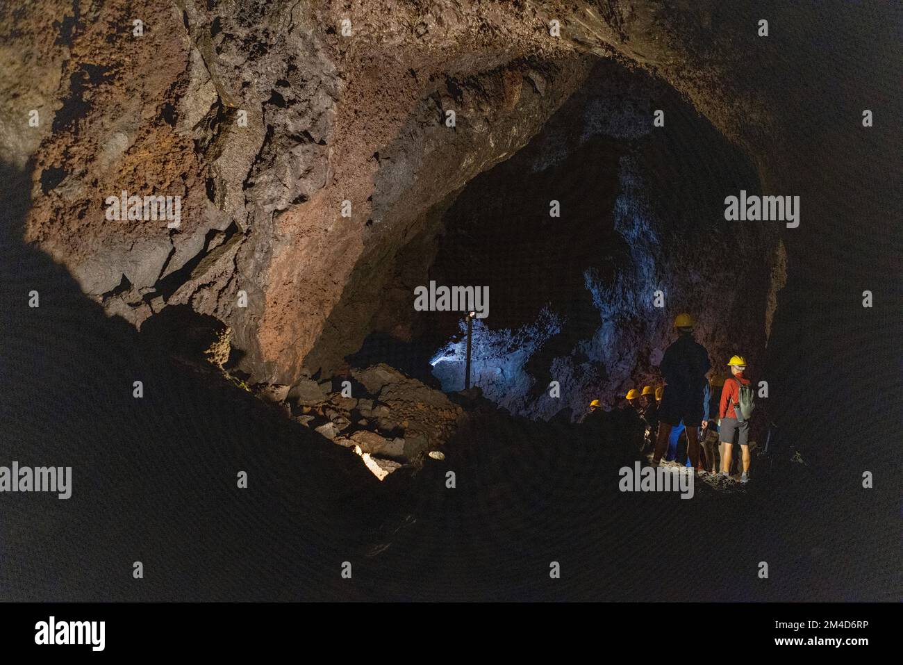 Group exploring a volcanic cave in the Volcanic Caves Park at the foot ...